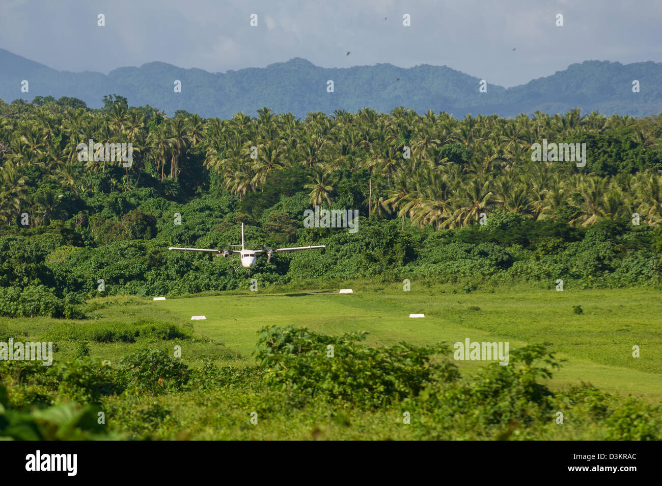 Air Vanuatu plane landing at the grass airstrip at Longana, Ambae ...