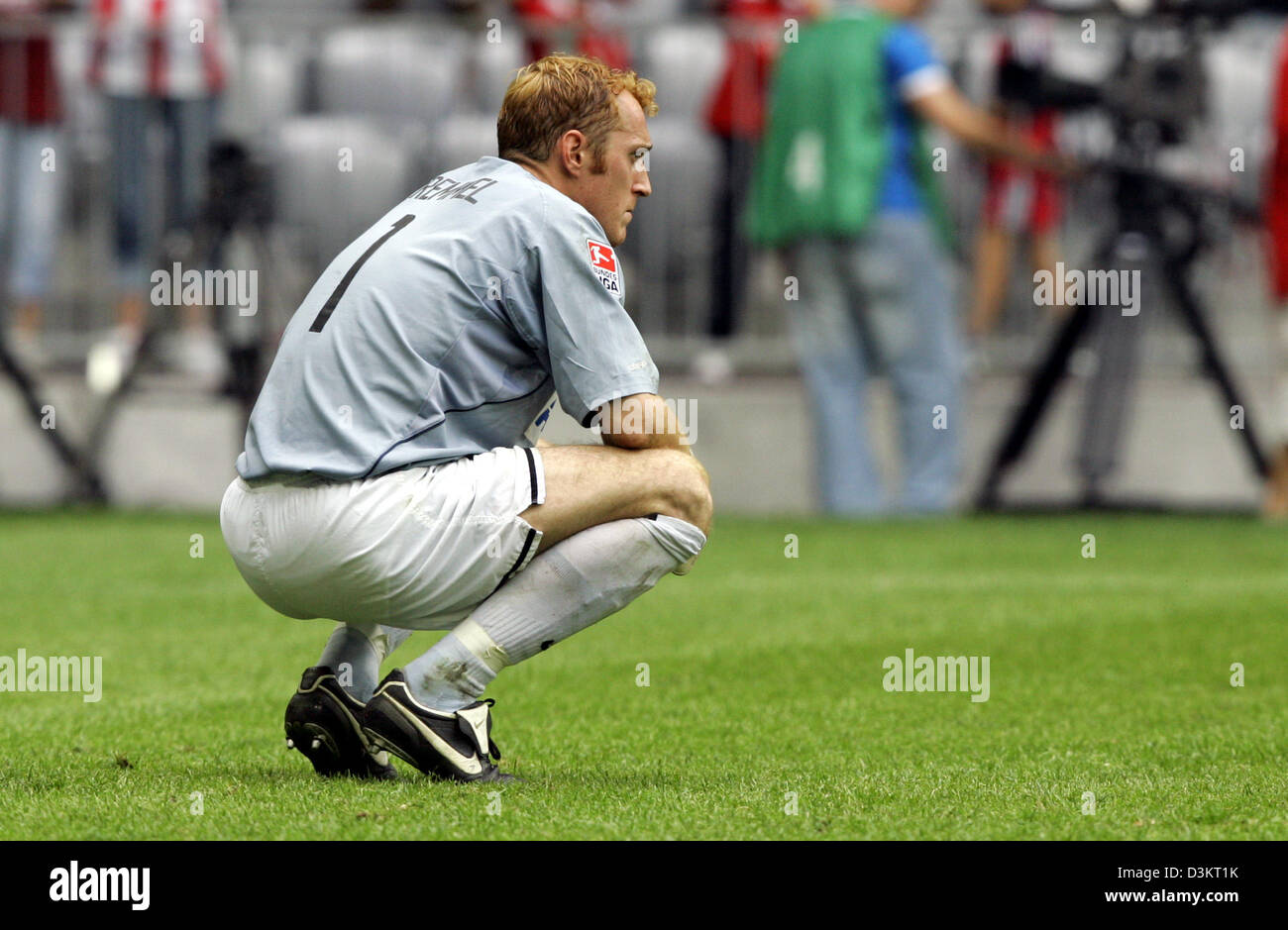 (dpa) - Berlin keeper Gerhard Tremmel sits disappointed on the grass ...