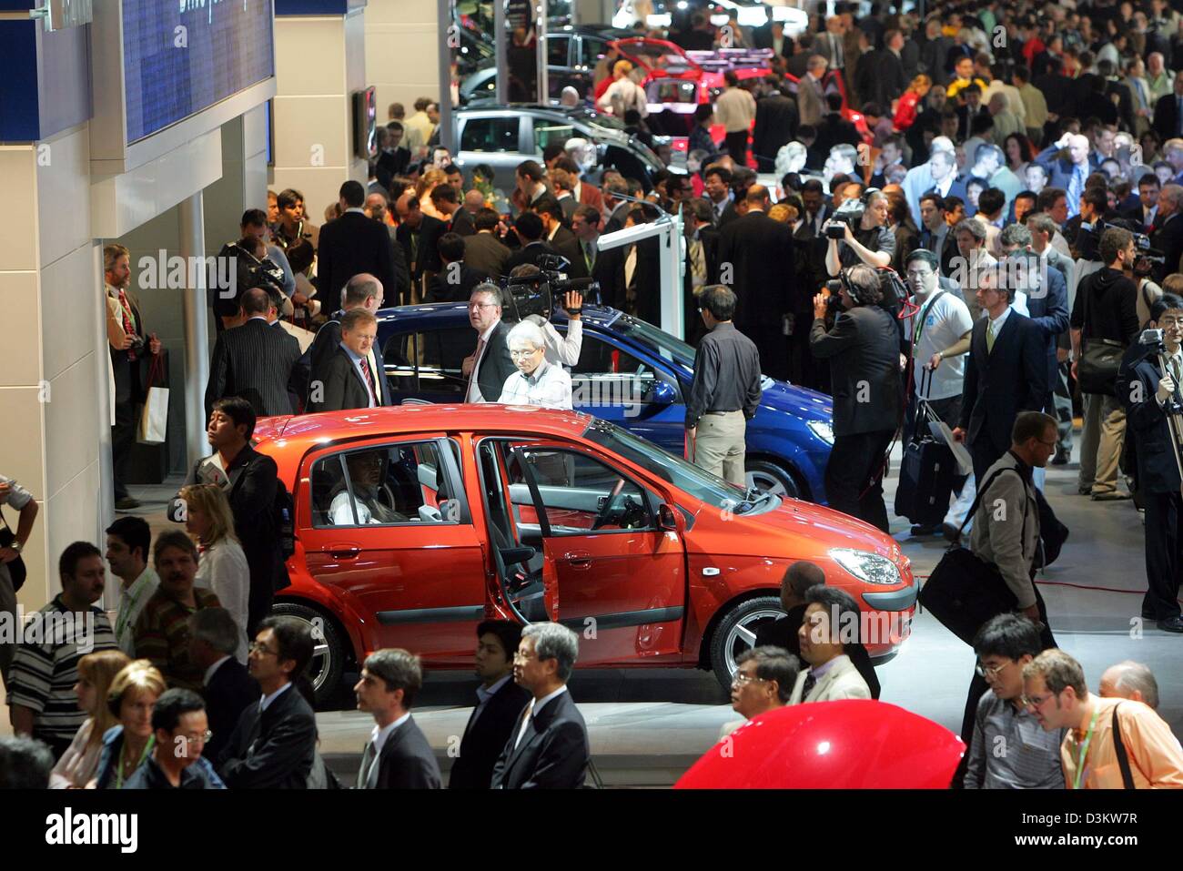(dpa) - Visitors mingle pass the exhibition stands of car manufacturer ...