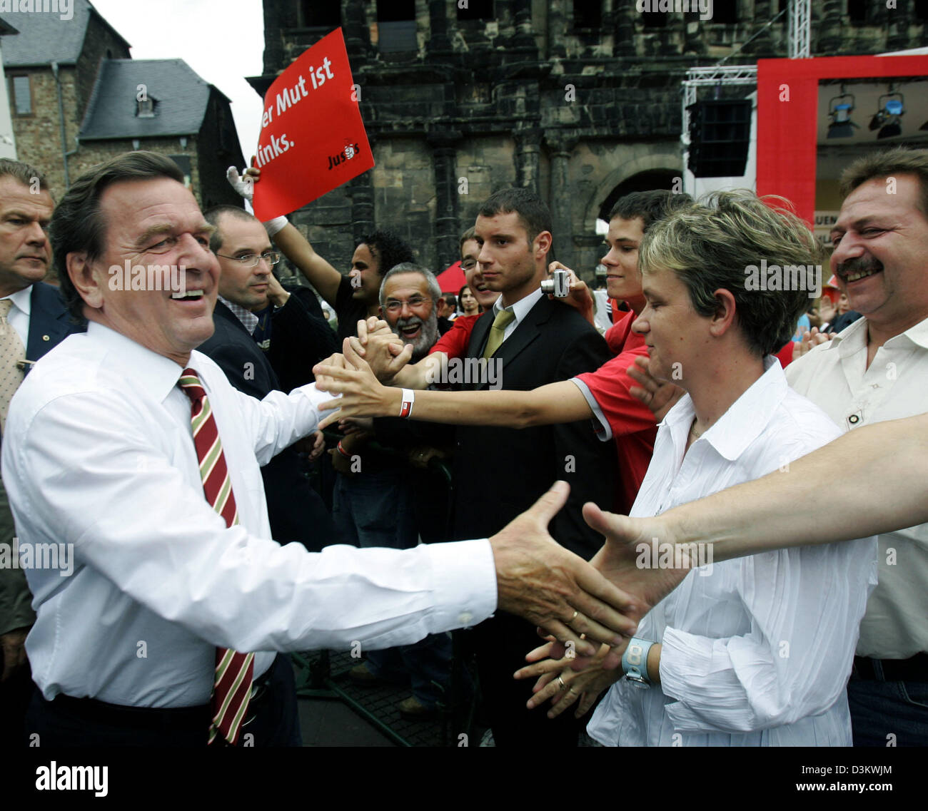 A smiling German Chancellor Gerhard Schroeder greets fans in front of ...