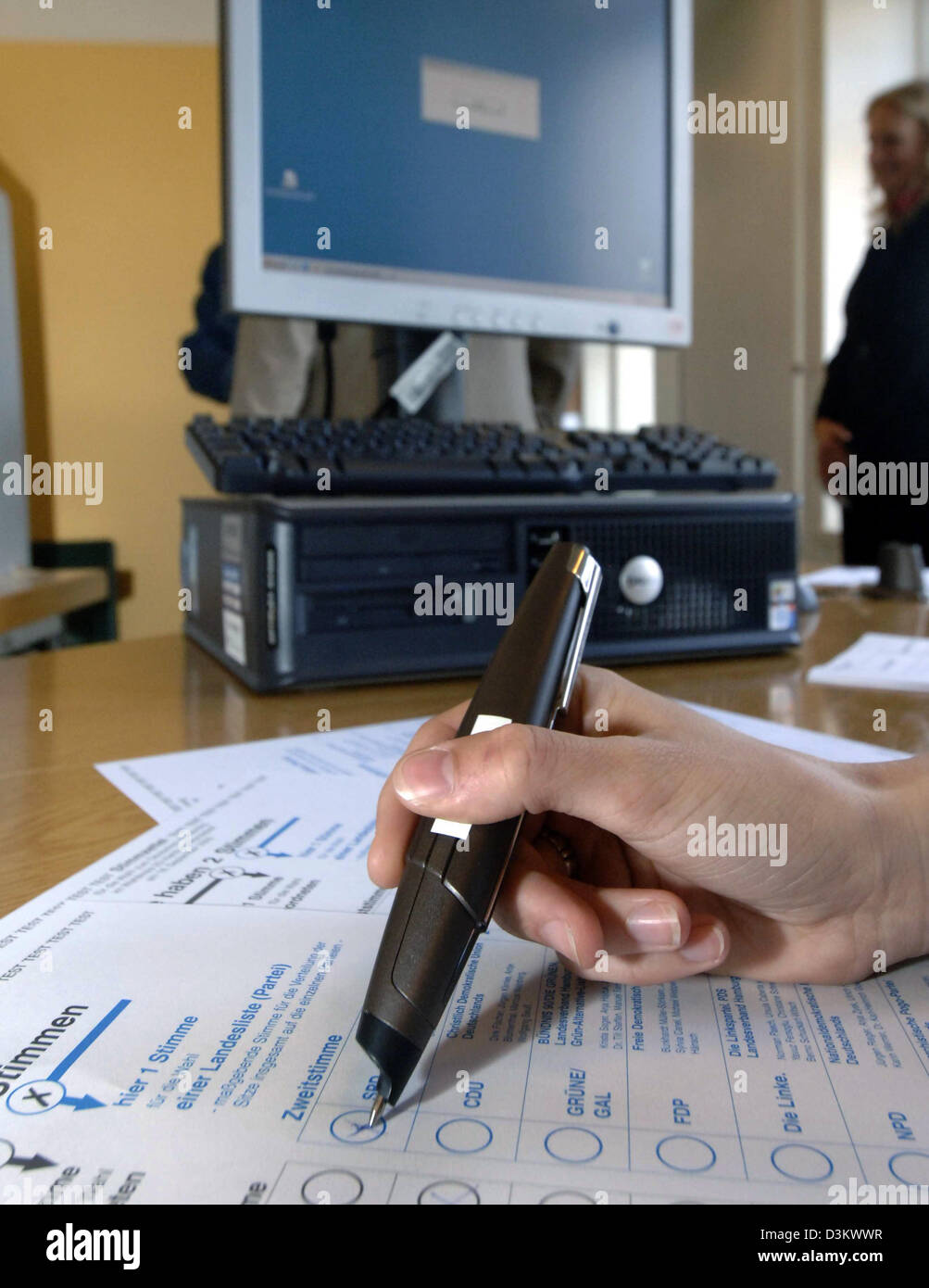 (dpa) - A woman tries out a digital election pen on a ballot in Hamburg ...