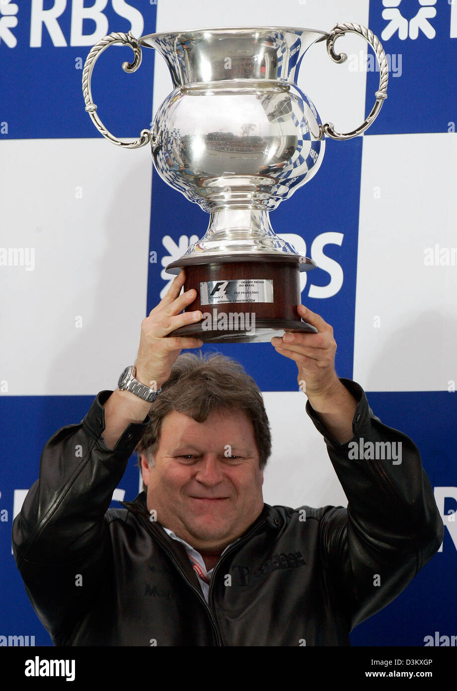 (dpa) - Head of Mercedes Motorsport German Norbert Haug lifts the ...