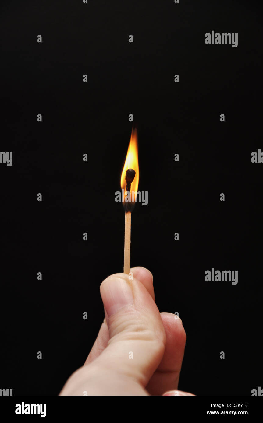 Fingers holding a lit match Stock Photo - Alamy