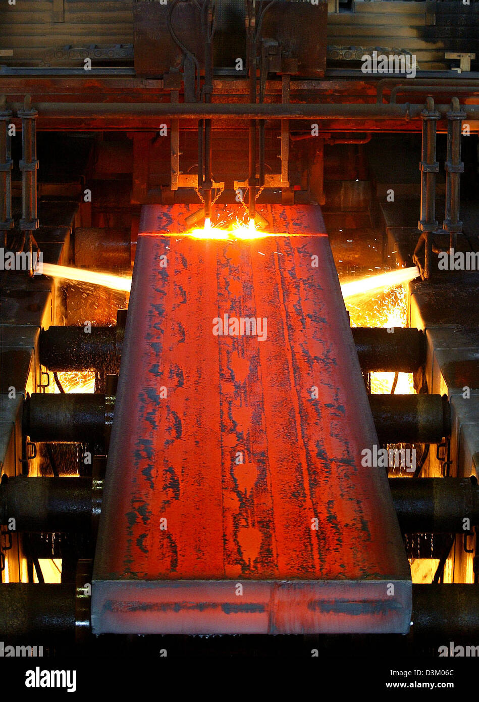 (dpa) - A steel slab gets cut on the run-out of the slab casting ...