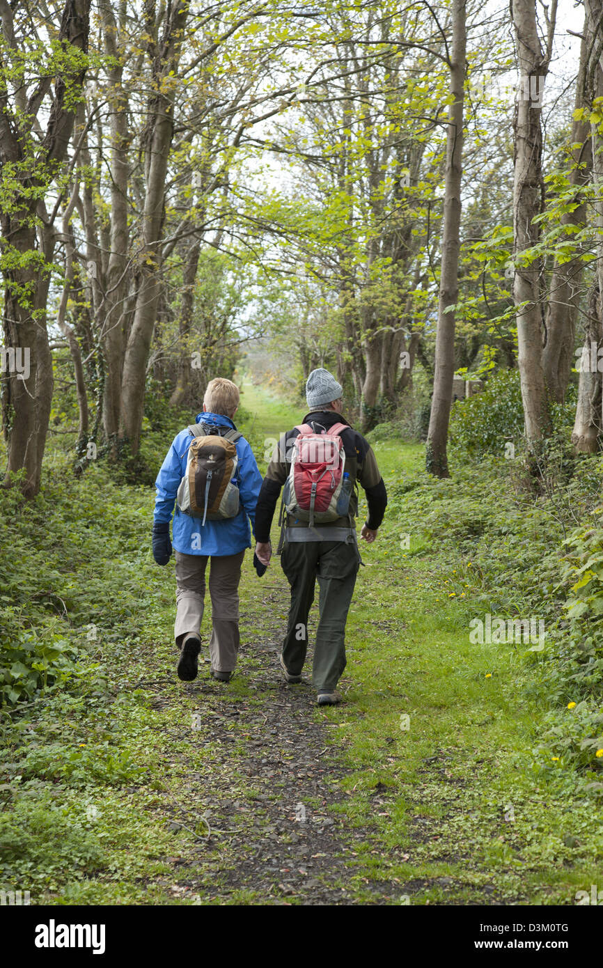 Couple walking along the Dundrum Coastal Path, County Down, Northern ...