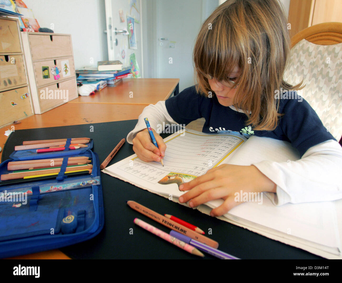 (dpa) - Seven-years-old Ruby sits at the desk doing her homework at her ...