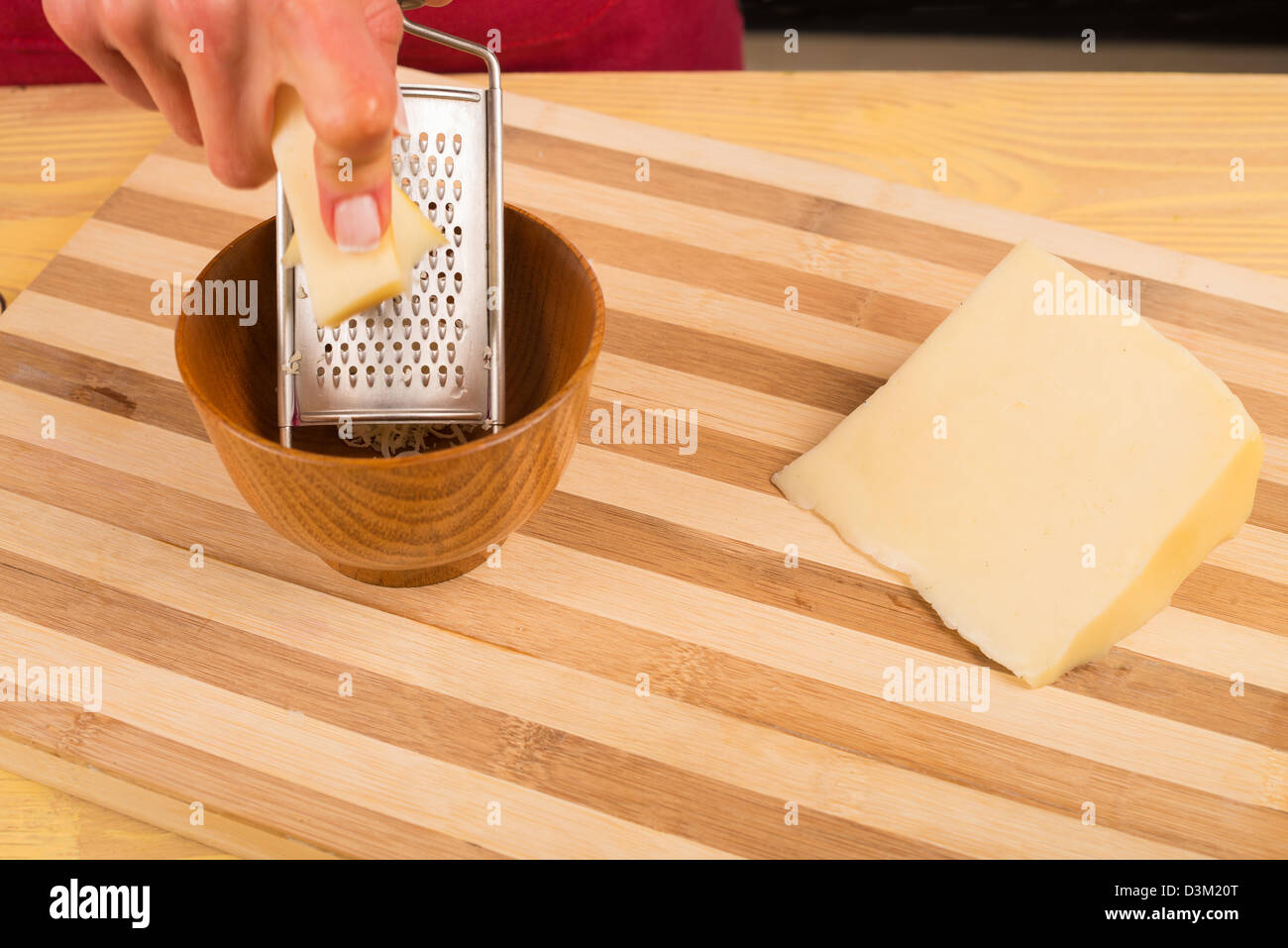 Grating cheese for the extra fresh flavor Stock Photo - Alamy