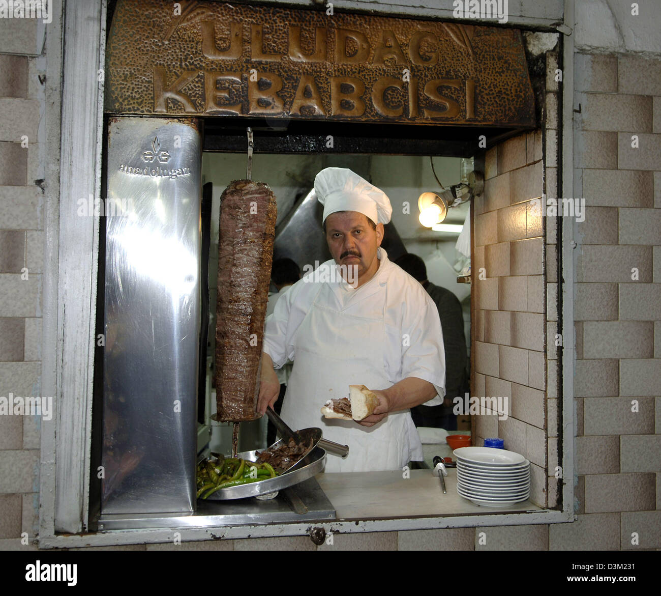 (dpa) - The picture shows a man selling Doner Kebab at his stand in ...