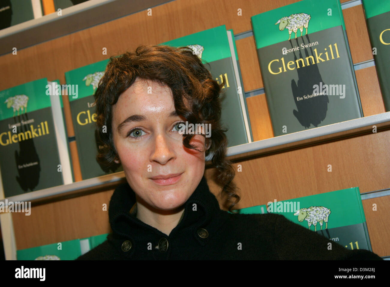 (dpa) - German author Leonie Swann stands in front of a rack with ...