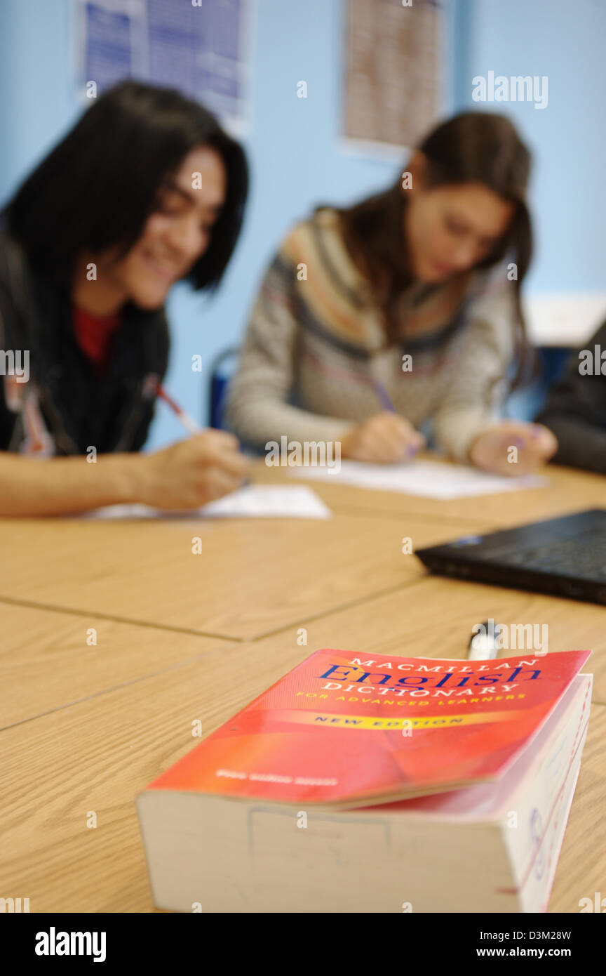 International students at UK University, with an English dictionary in ...