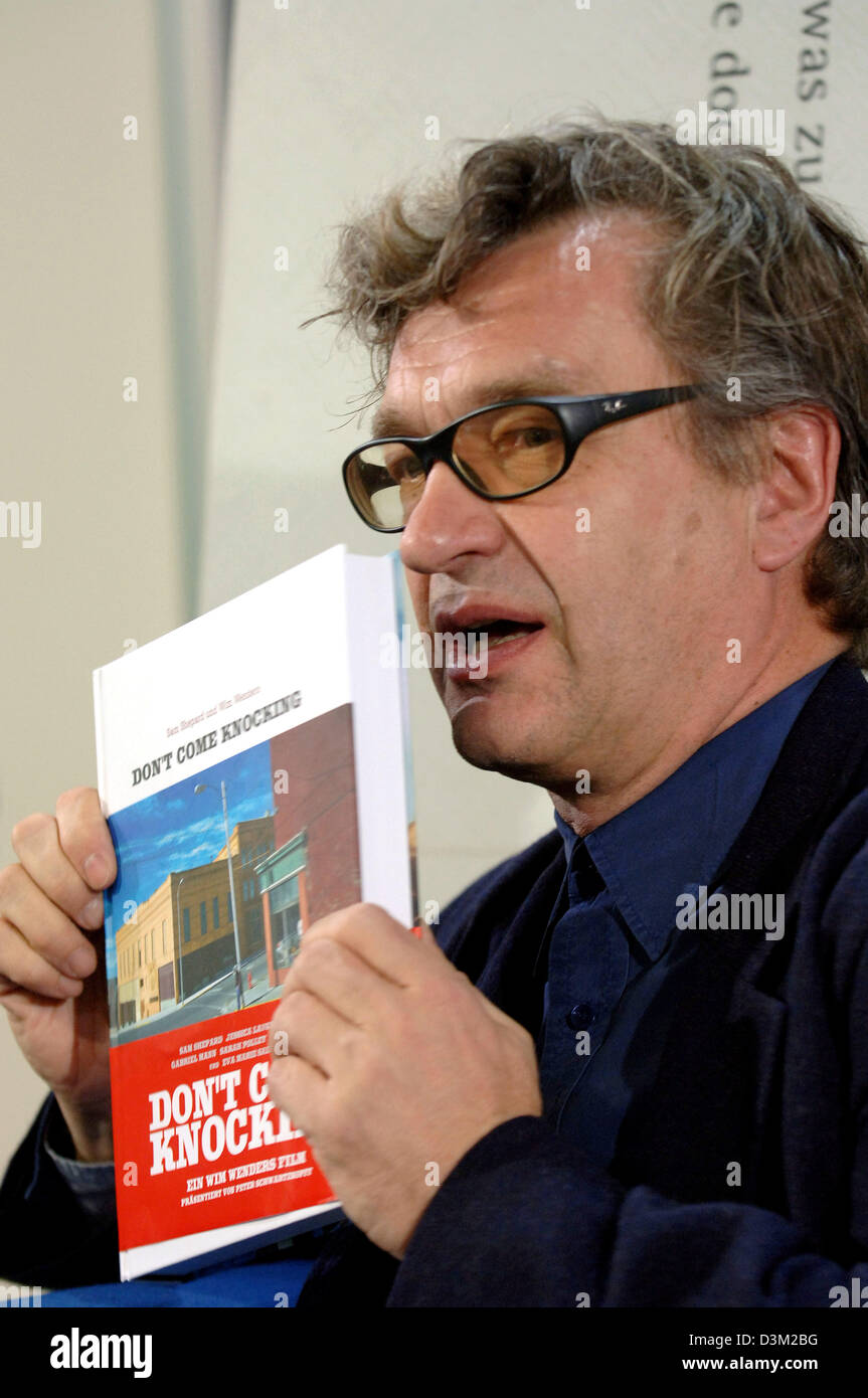 (dpa) - German film maker and writer Wim Wenders hold the book to his ...