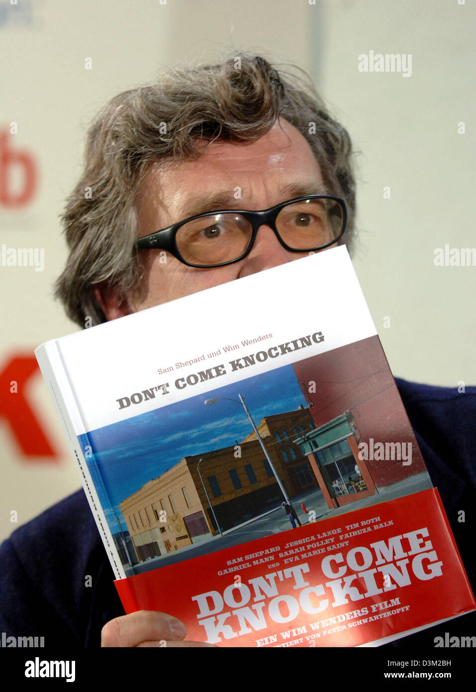 (dpa) - German film maker and writer Wim Wenders covers his face with ...