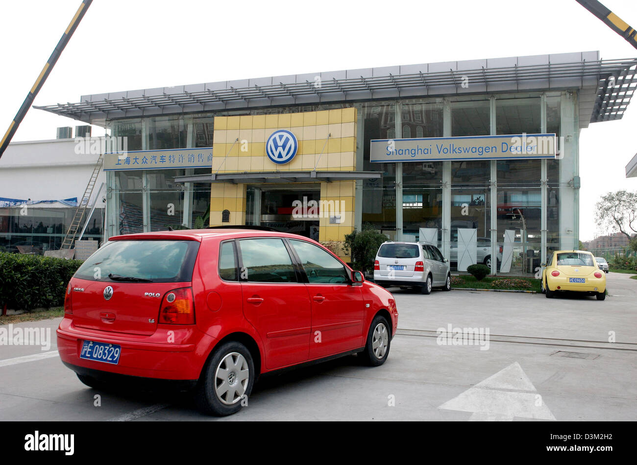 (dpa) - A red Volkswagen (VW) car drives through the gates onto the ...