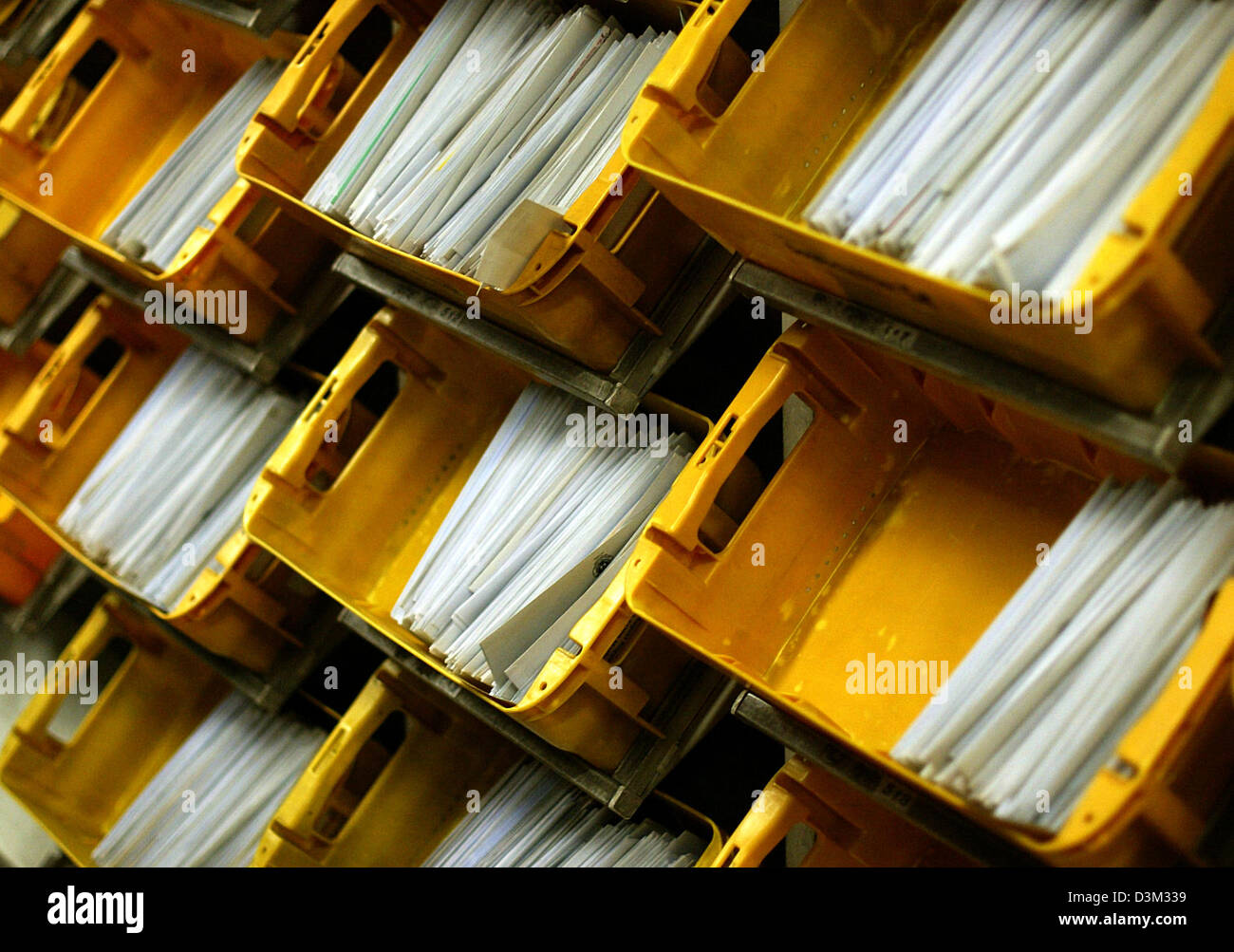 (dpa) - Boxes for mail of the Deutsch Post World Net get filled with ...