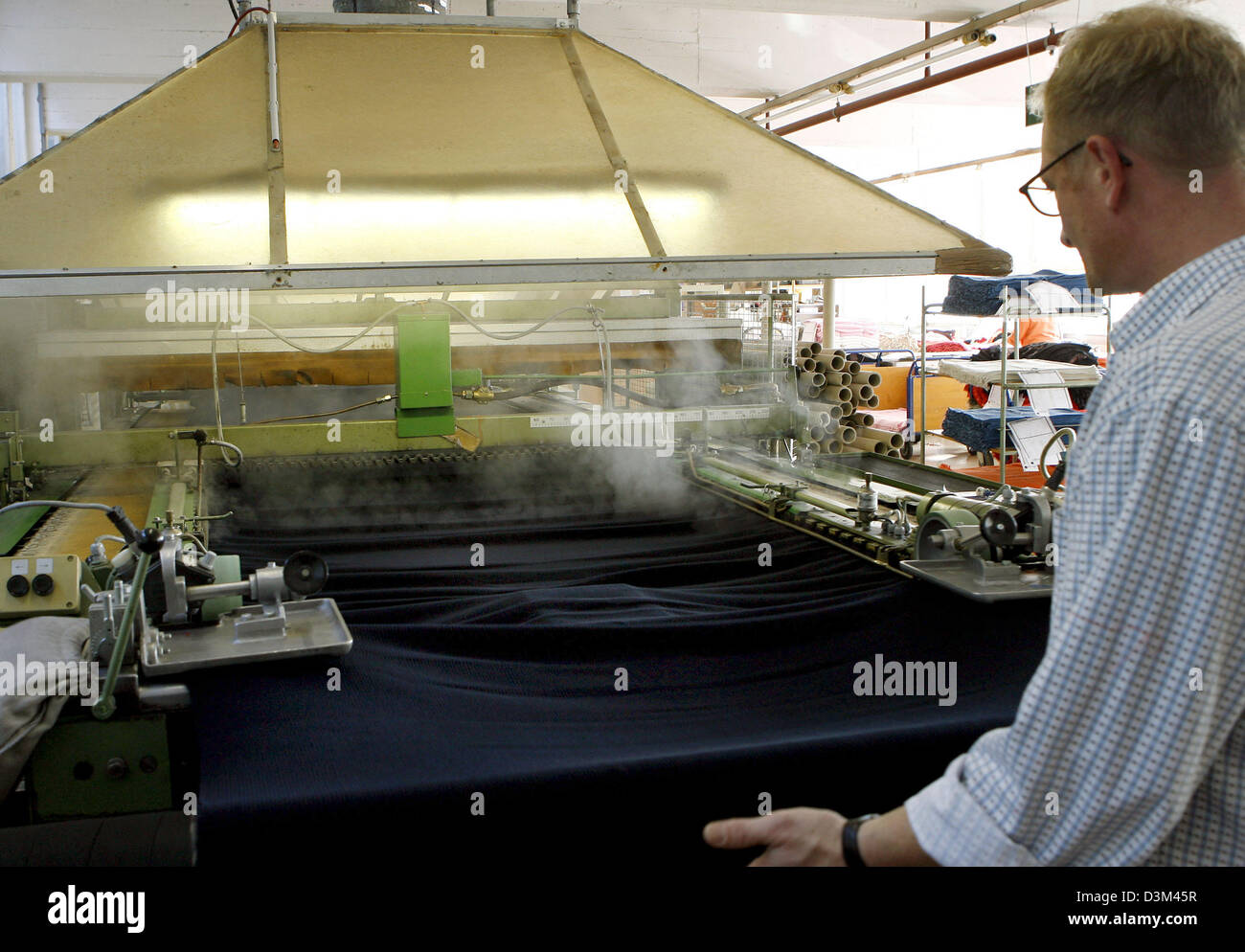 (dpa) - The picture shows an employee at work at German fashion label ...