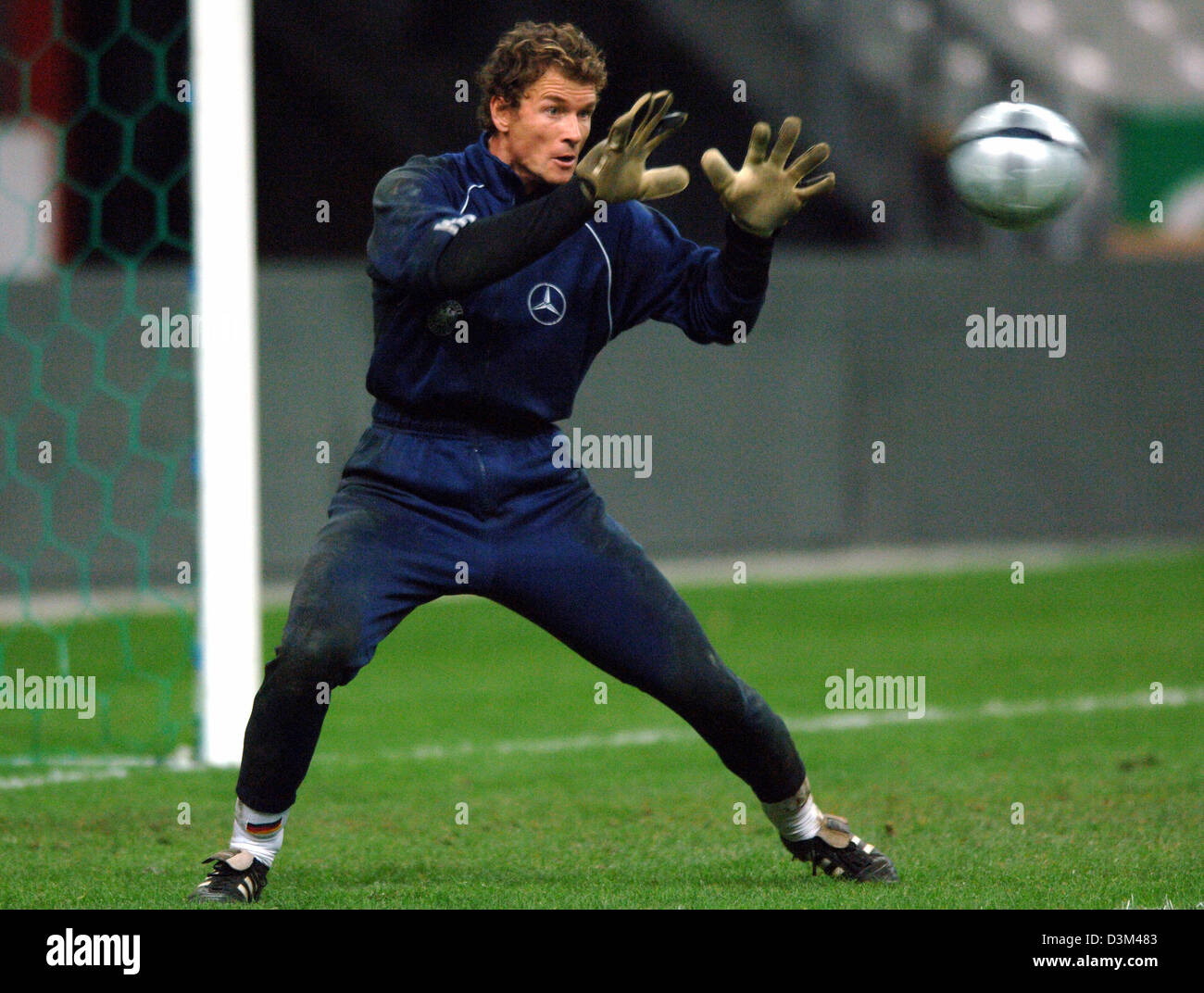 (dpa) - Germany's goalkeeper Jens Lehmann catch a ball as he stand in ...