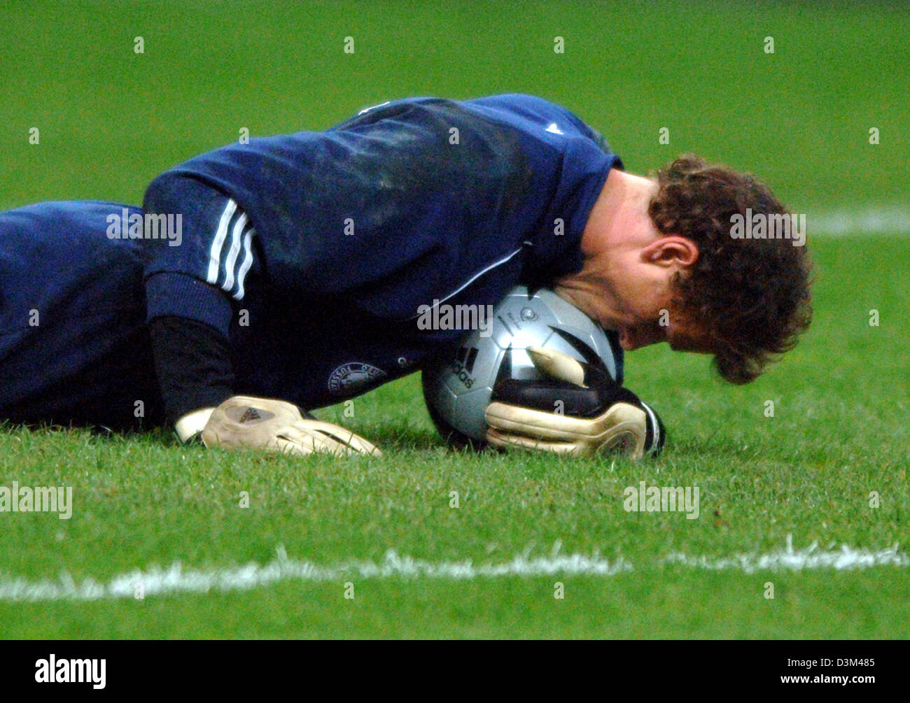 (dpa) - Germany's goalkeeper Jens Lehmann lies on a soccer ball on the ...