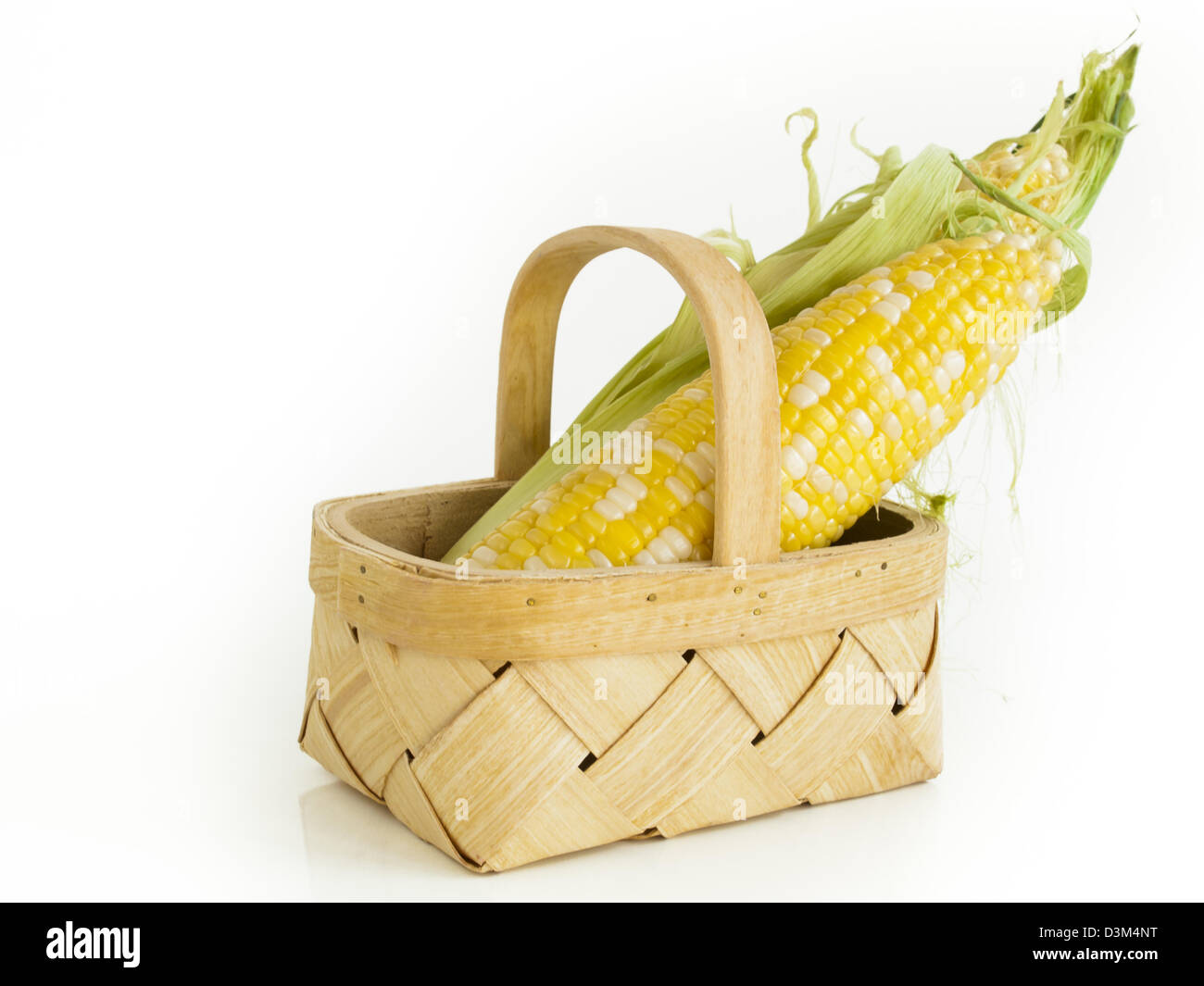 Olathe sweet corn in basket on white background Stock Photo - Alamy