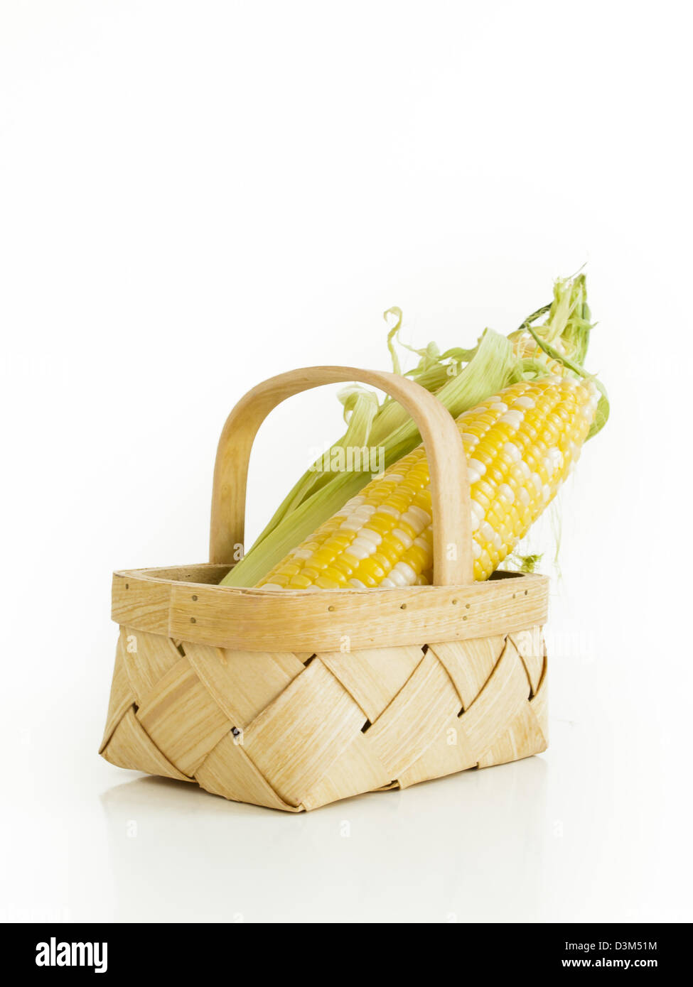 Olathe sweet corn in basket on white background Stock Photo - Alamy