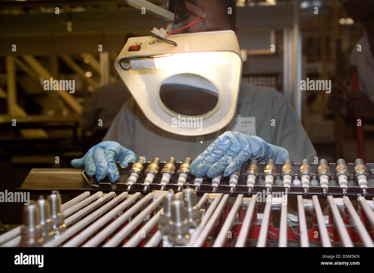 (dpa) - The photo shows the final manufacturing stage of spark plugs at ...