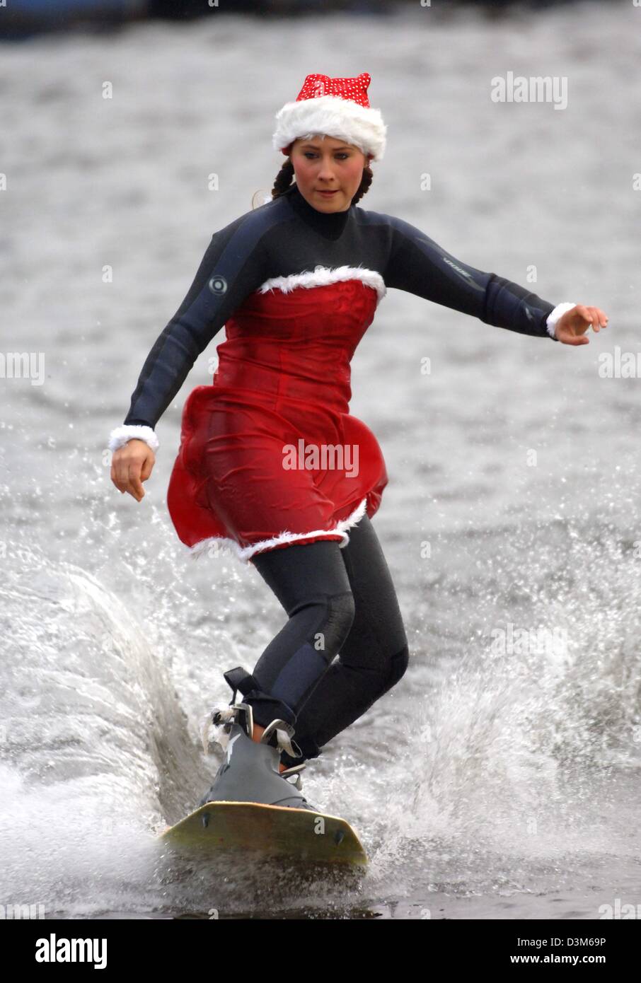 (dpa) - A female wakeboarder wearing a Saint Nicholas costume surfs at ...