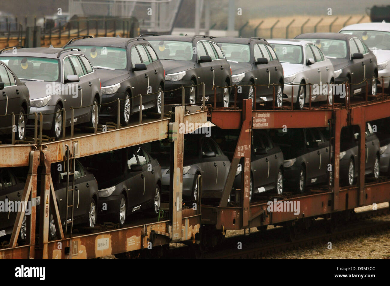 (dpa) - The picture shows new BMW cars on a freigth waggon ready for ...