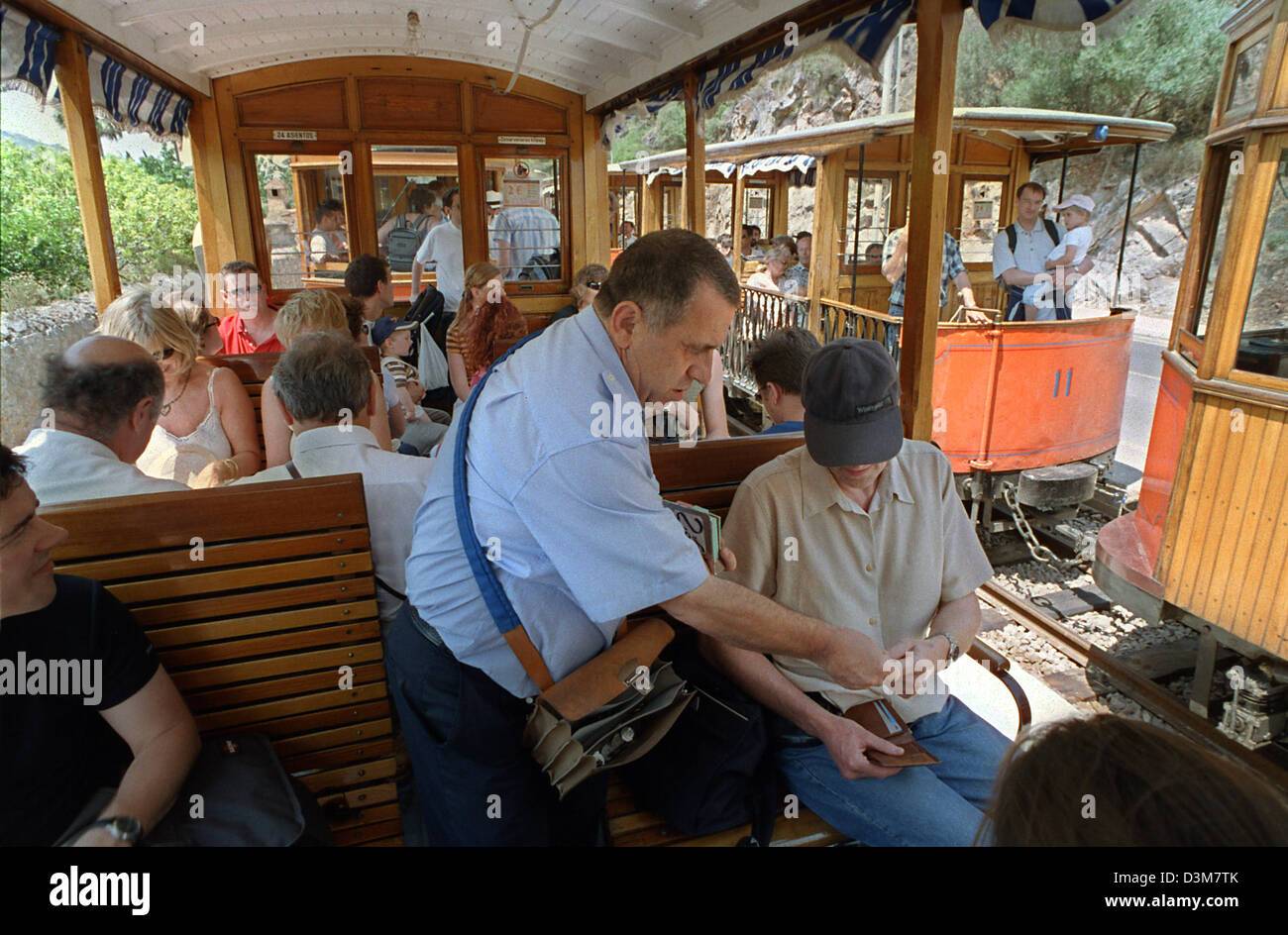 (dpa) FILE - A tramway conductor checks a passenger on the way from ...