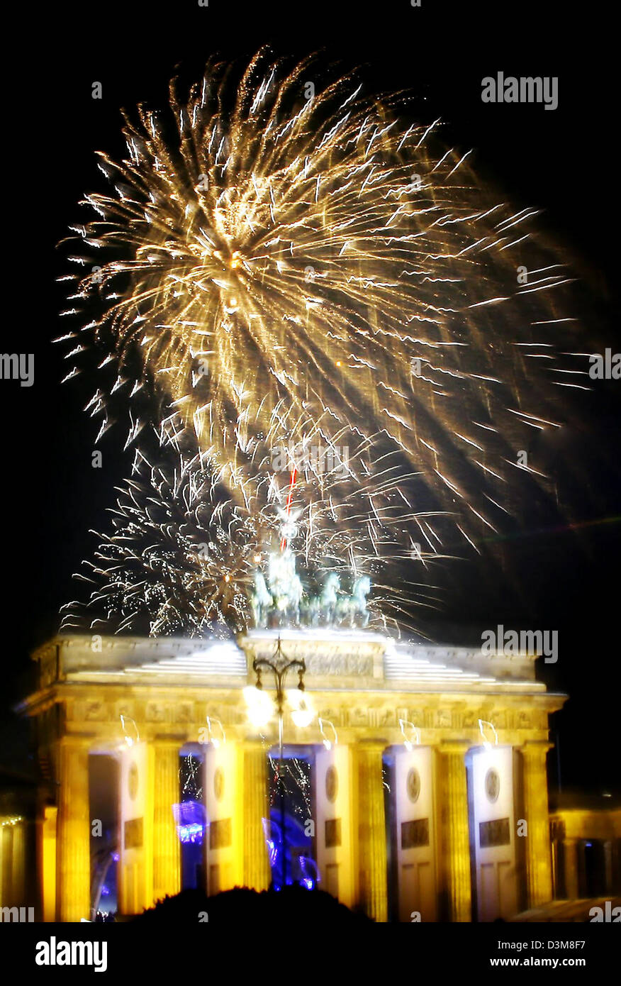 (dpa) - Fireworks explode in the sky over the Quadriga of the ...
