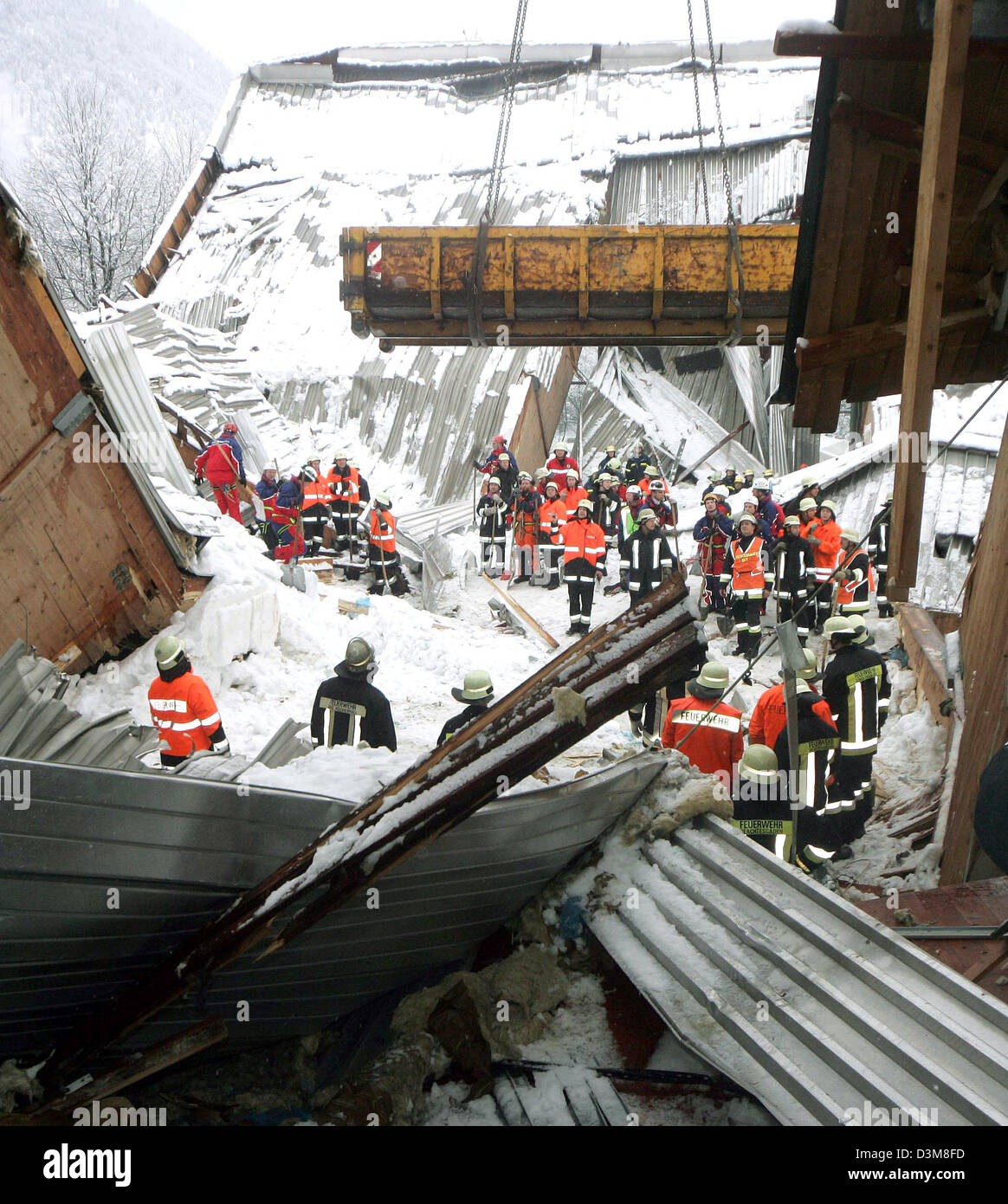 Rescue forces clear the collapsed skating rink from snow and debris in ...