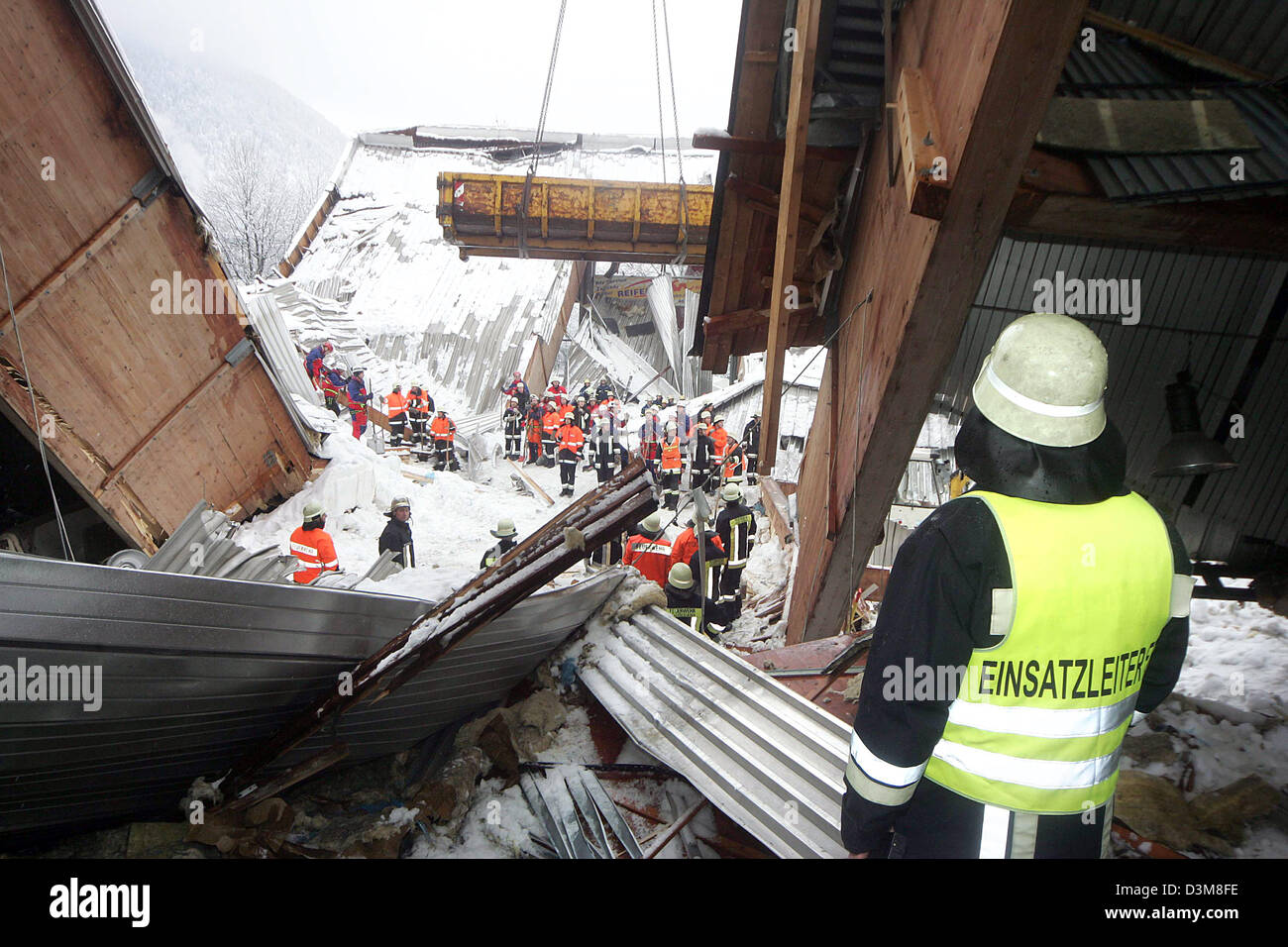 Rescue forces clear the collapsed skating rink from snow and debris in ...