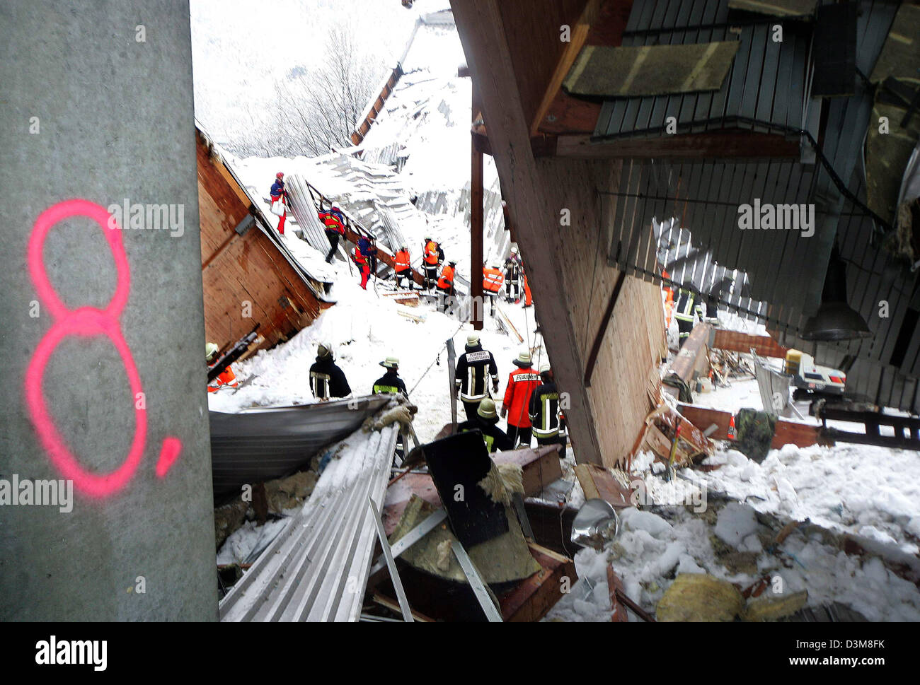 Rescue forces clear the collapsed skating rink from snow and debris in ...