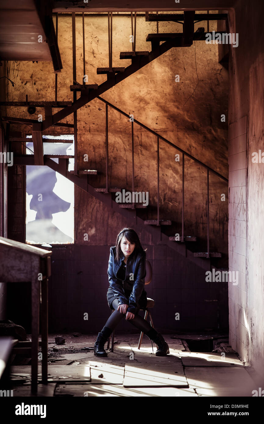 Young beautiful woman inside rusty building Stock Photo - Alamy