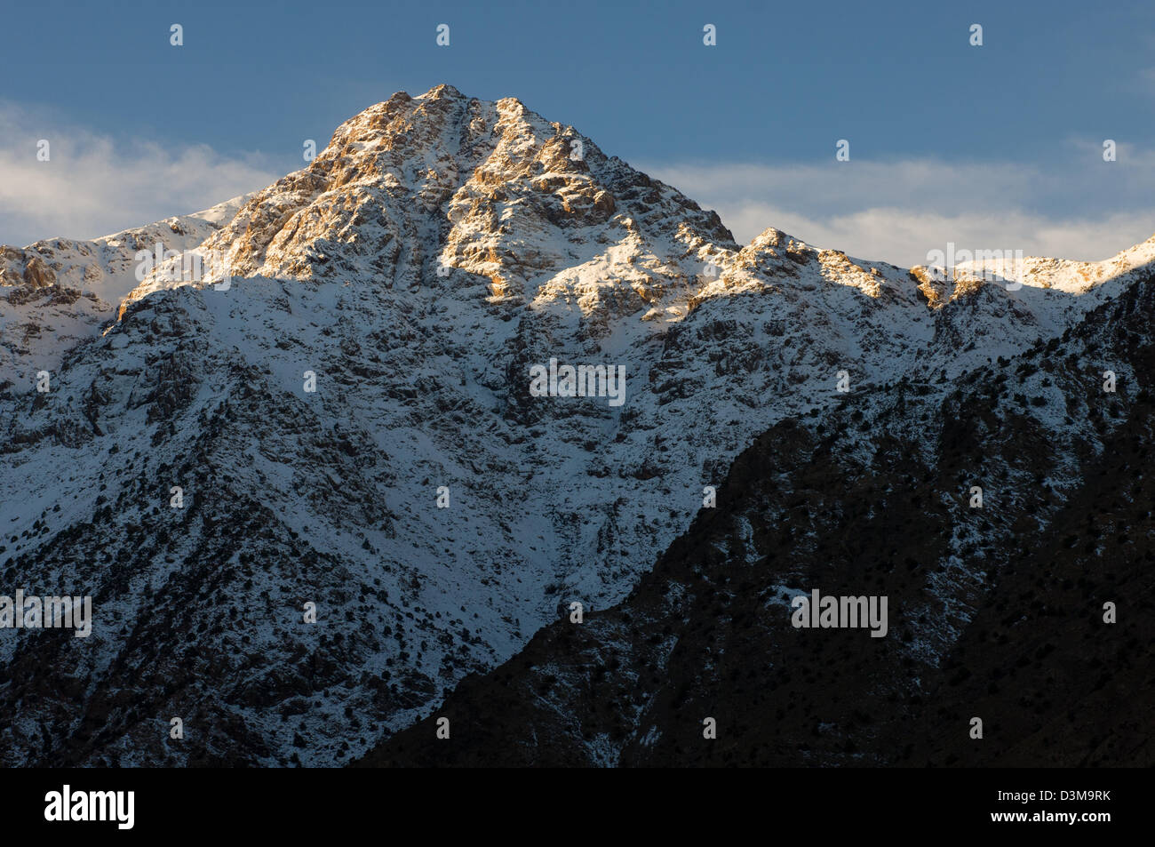 Snow on the peak of a mountain overlooking Aremd Village, near Imlil ...