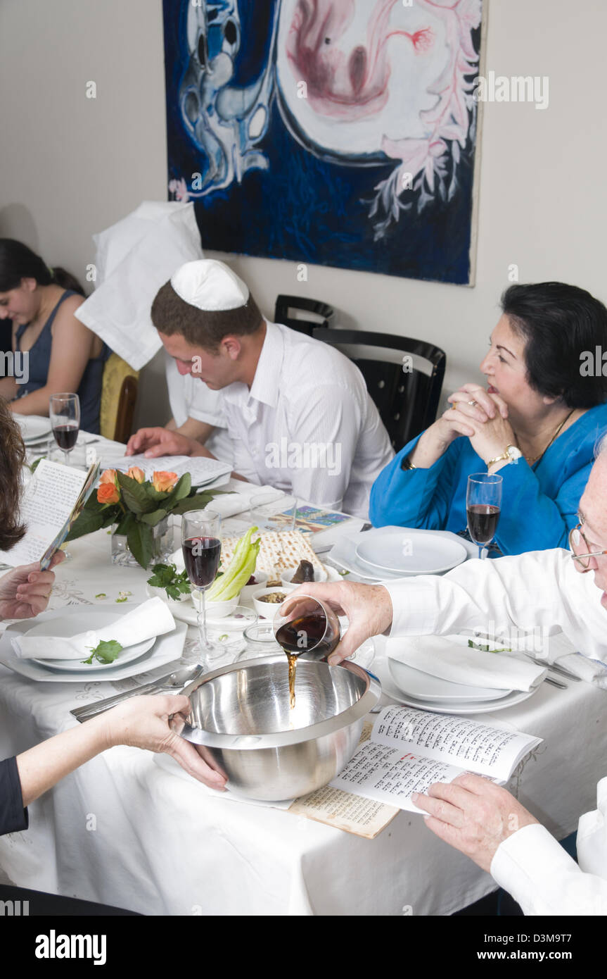 family sitting around a table set for a Jewish Festive meal on Passover ...