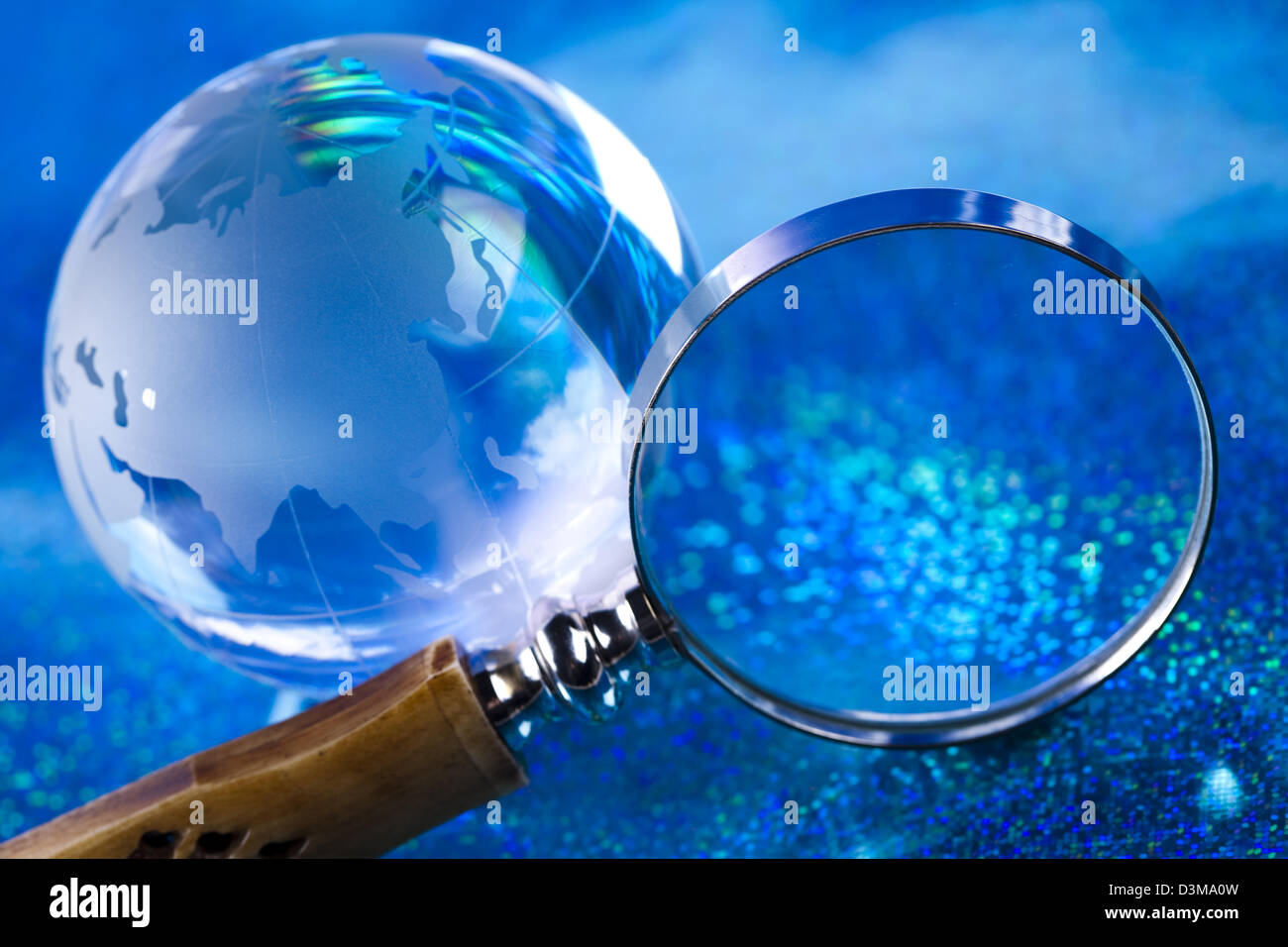 Magnifying glass and globe Stock Photo - Alamy