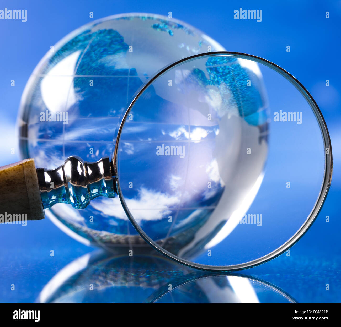 Magnifying glass and globe Stock Photo - Alamy