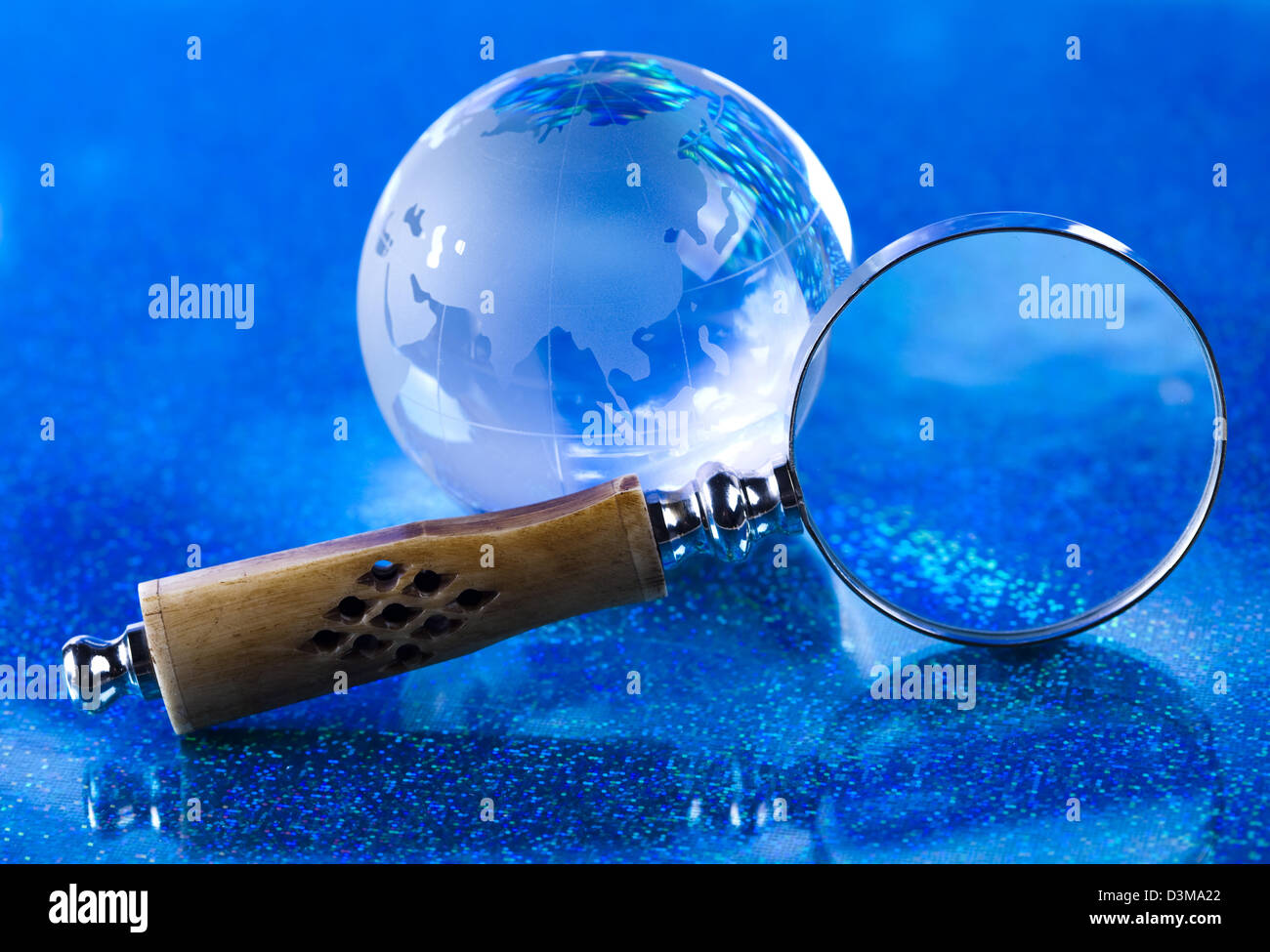 Magnifying glass and globe Stock Photo - Alamy