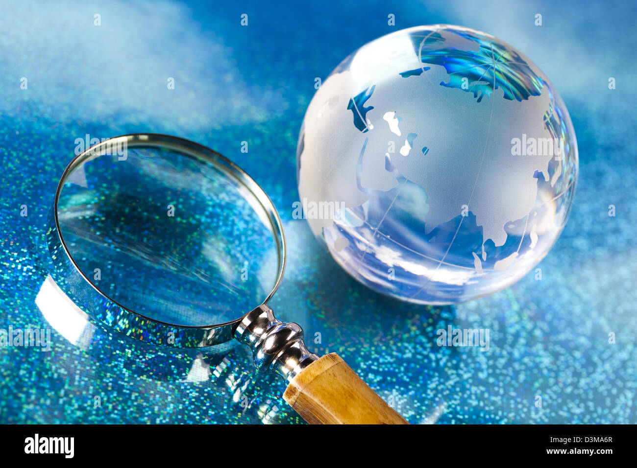 Globe and Magnifying glass Stock Photo - Alamy