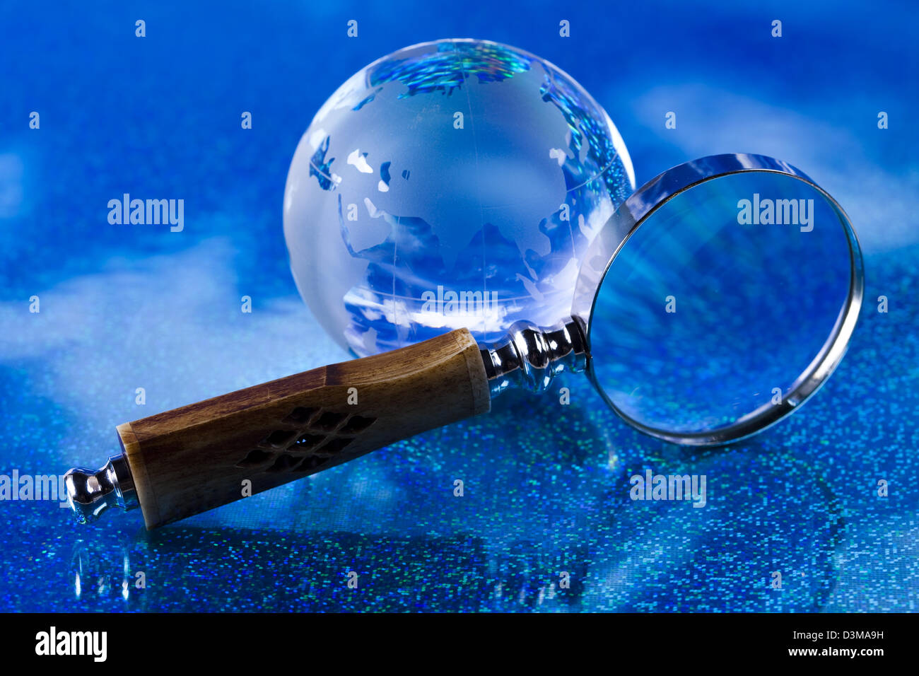 Globe and Magnifying glass Stock Photo - Alamy