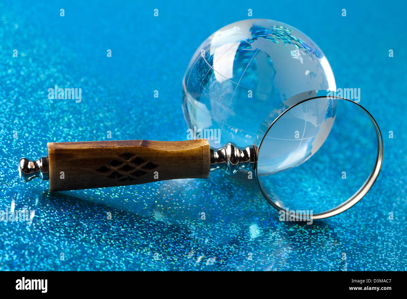 Globe and Magnifying glass Stock Photo - Alamy
