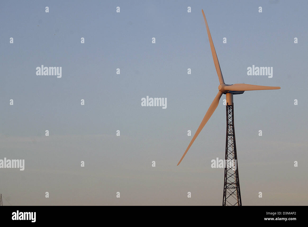 (dpa) - A wind energy wheel pictured in the light of the rising sun in ...