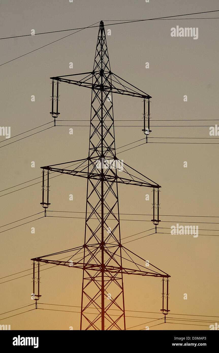 (dpa) - A power pole pictured in the light of the rising sun in ...