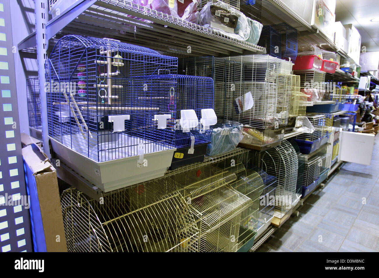 The picture shows bird cages of different shapes and colours at a pet ...