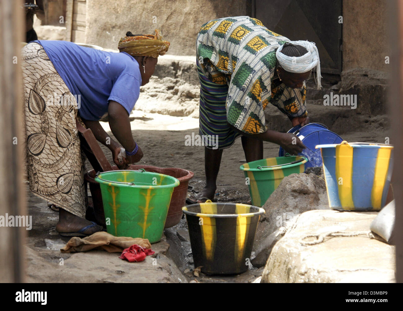 Human interest hum travel female gesture washing laundering buckets ...