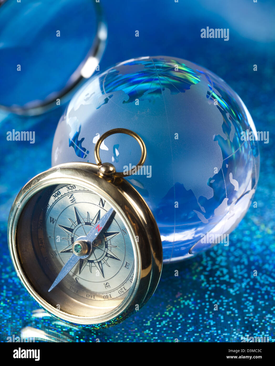 Magnifying glass, Compass and globe Stock Photo - Alamy