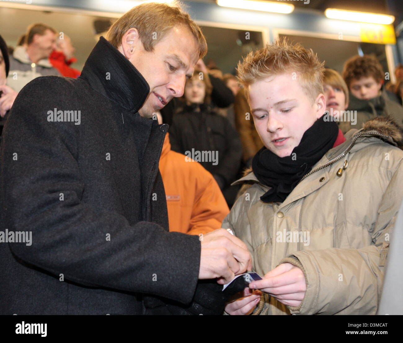 Germany's national soccer coach Juergen Klinsmann signs an autograph ...