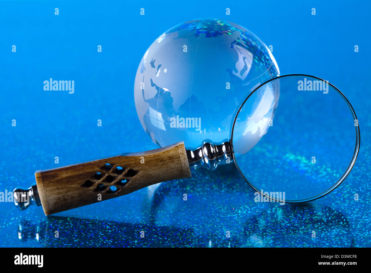 Globe and Magnifying glass Stock Photo - Alamy
