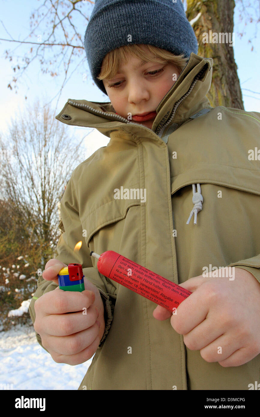 A kid lights a firecracker in Frankfurt Main, Germany, 30 December 2005 ...