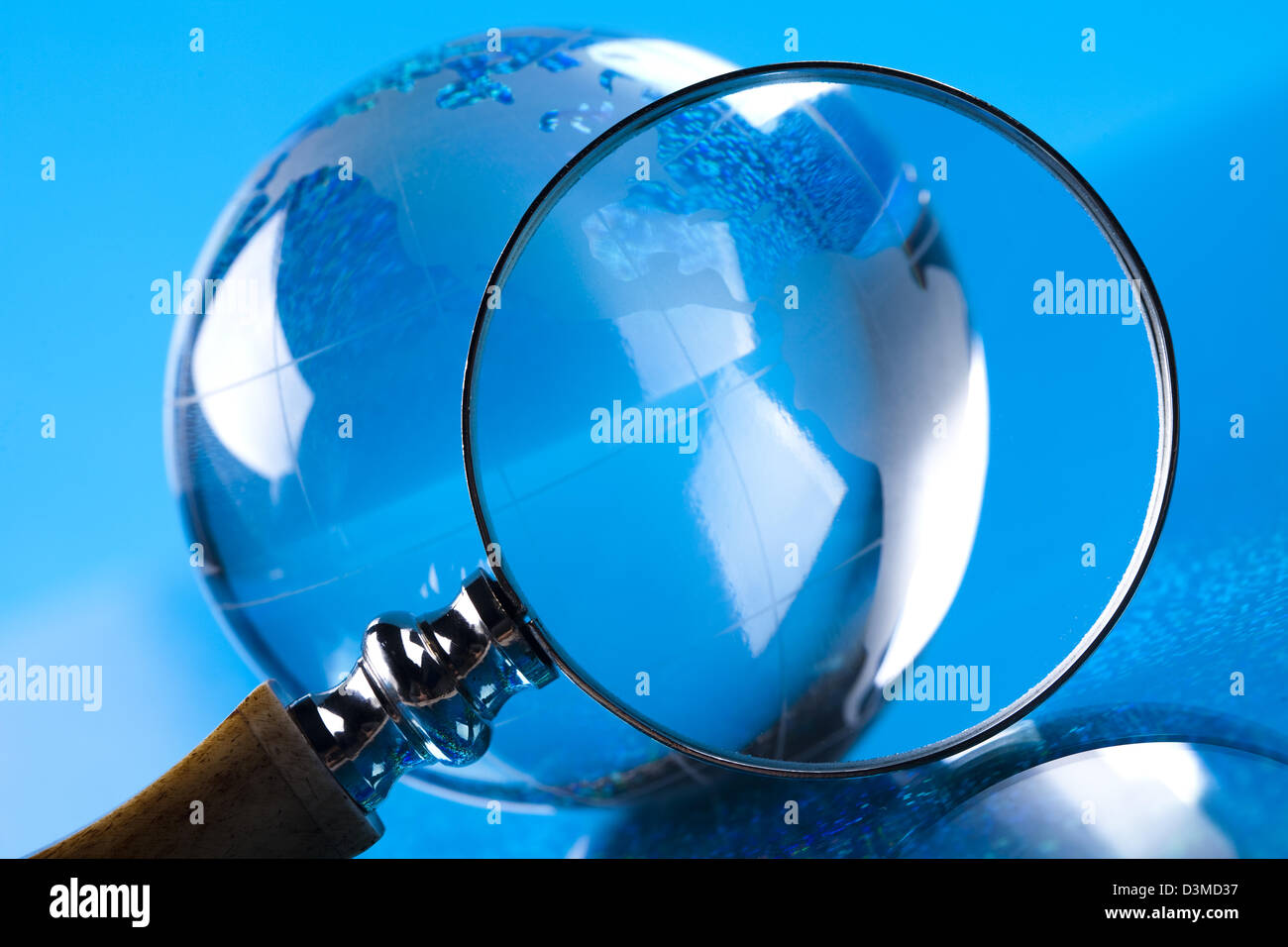 Globe and Magnifying glass Stock Photo - Alamy