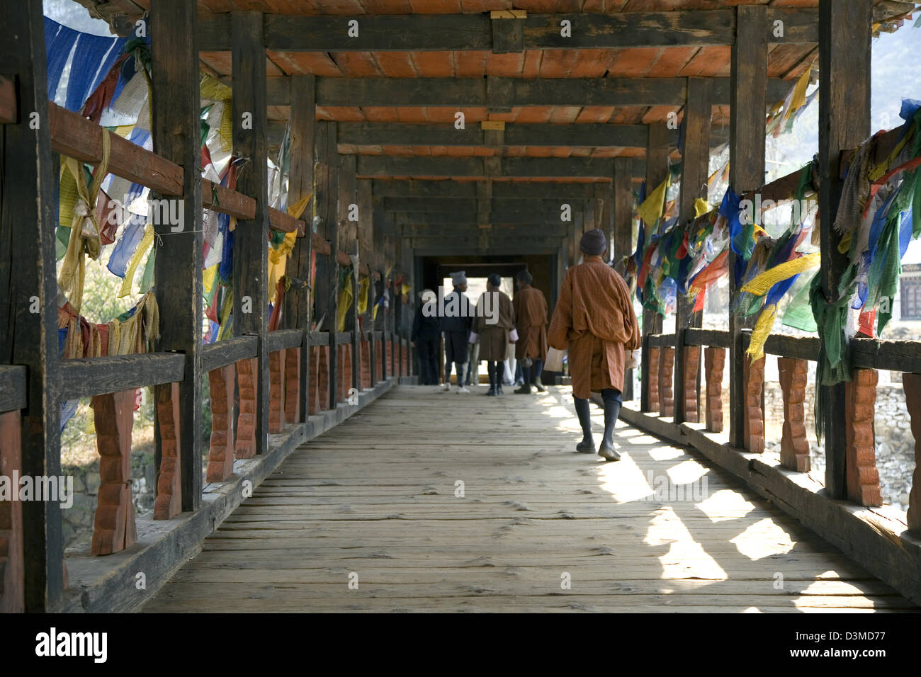 An ancient wooden bridge spanning the Paro Chhu (river) leads to the ...
